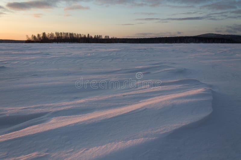 Early Morning On The Frozen Snow Covered Lake Ripples In The Snow