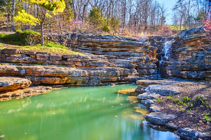 Early Spring View of Waterfall through Jagged Rocks into Majestic ...