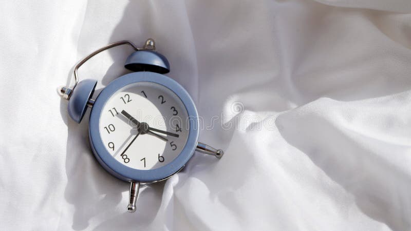 Vintage clock lay on bed. stock image. Image of background - 242428691