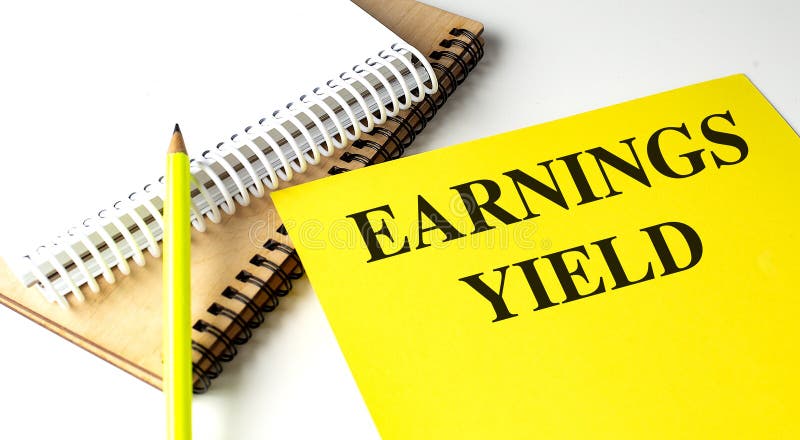 EARNINGS YIELD Text on Yellow Paper with Notebooks Stock Image - Image ...