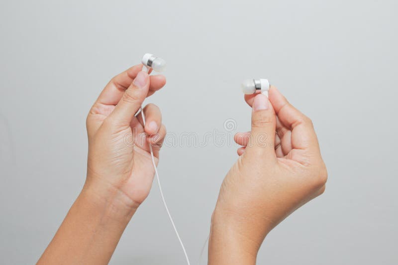 Hand holding earphone stock photo. Image of discussion - 30197866
