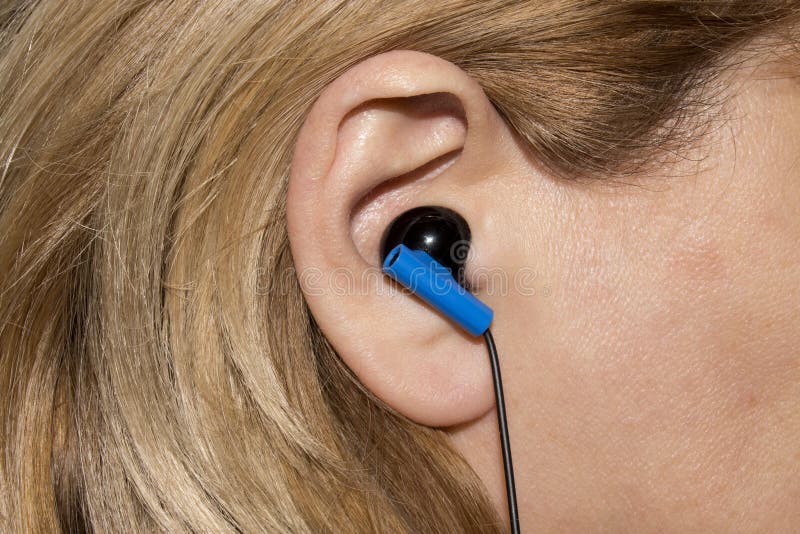 Earpiece in the human ear. stock photo. Image of earpiece - 137893606