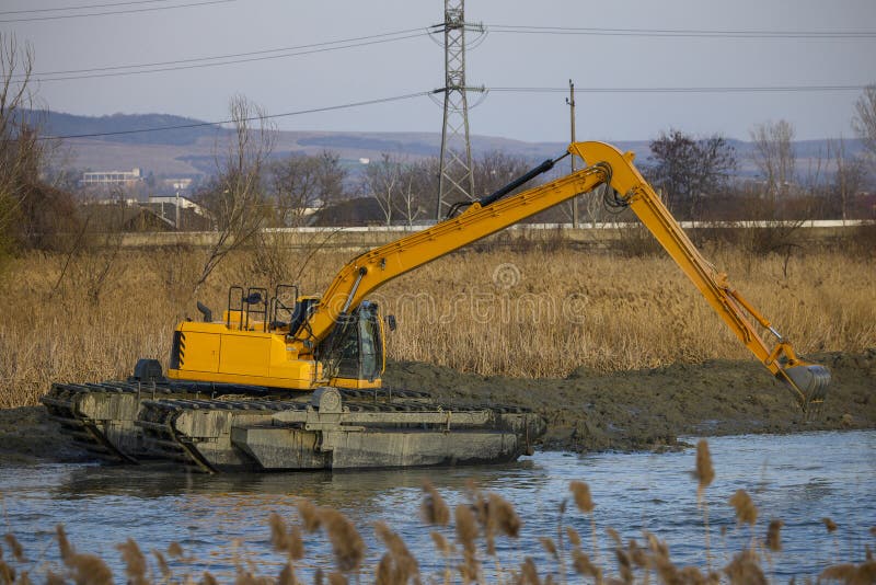 Earth Digger, Excavator, at the River S Shore Stock Image - Image of ...