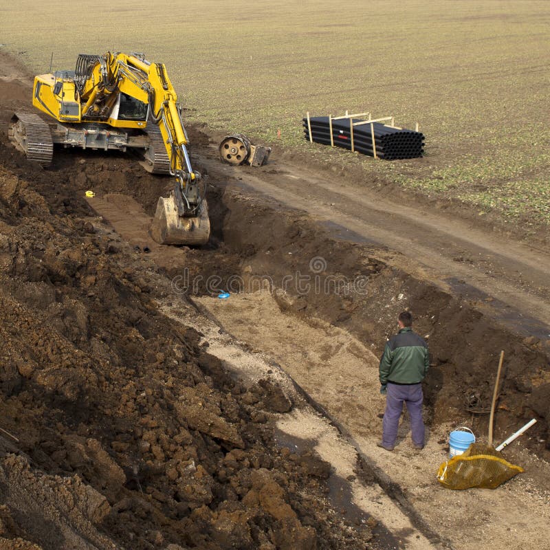 Earth mover and workman stock image. Image of excavating - 18902003