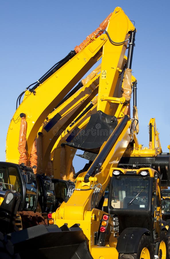 Earth Moving Equipment in a Row Stock Photo - Image of mechanical ...