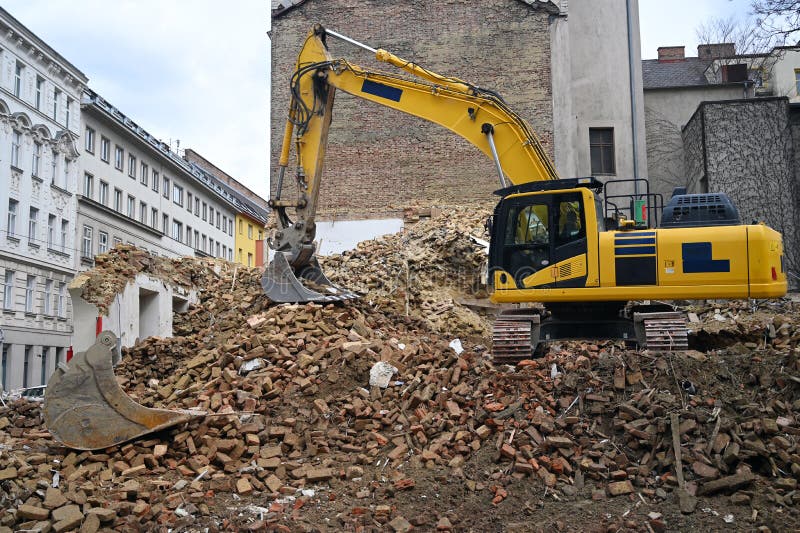 Earth Moving Machine Tearing Down an Old Building Stock Photo - Image ...