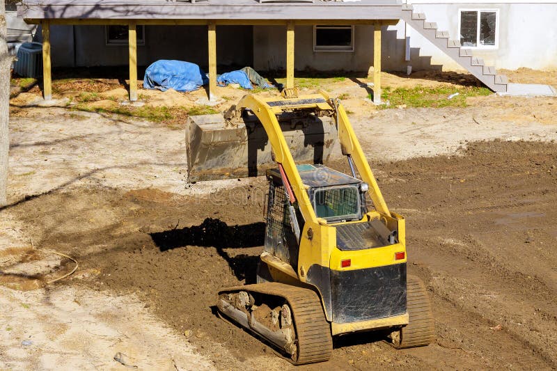 An Earthmoving Tractor is Leveling Ground at a Construction Site for ...