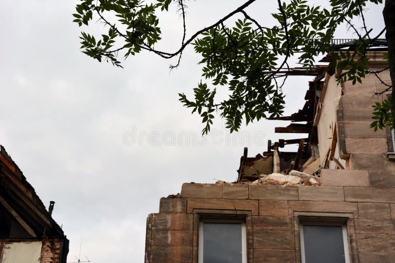 An Earthquake-damaged Wall of a Residential Building with Windows and a ...