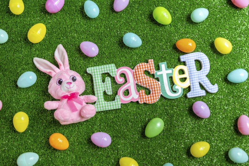 Easter Banner Letters with Scatter Plastic Easter Eggs and Plush Bunny ...