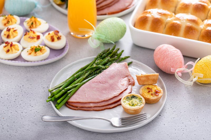 Easter Brunch Table with a Potion of Ham with Asparagus on the Plate ...