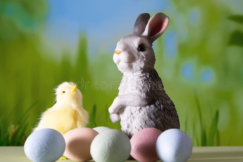 Easter Bunny with Chicken and Colored Eggs on a Background of Green ...
