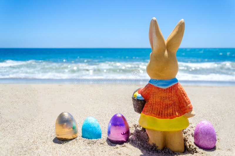 Easter Bunny with Color Eggs on the Ocean Beach Stock Image - Image of ...