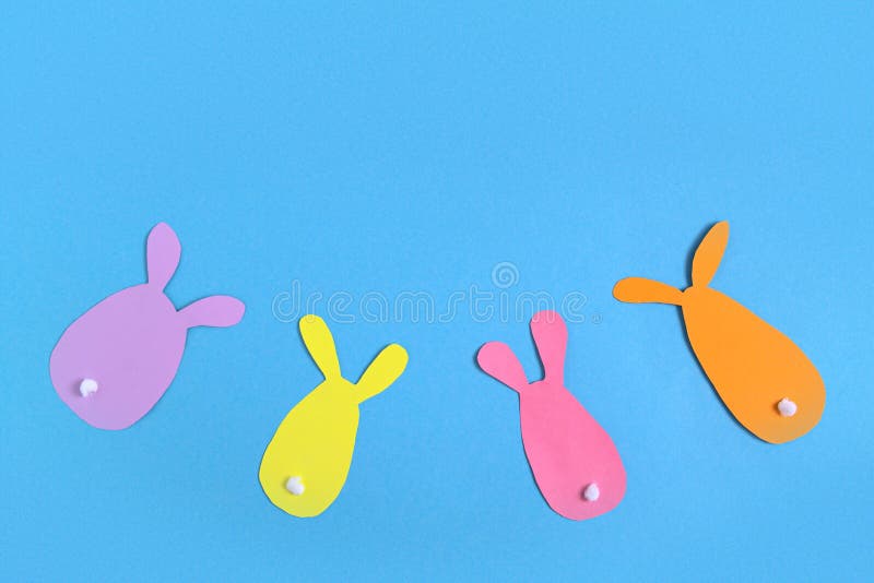 Easter Bunny Cut Out of Colored Paper. Layout on Blue Background. the ...