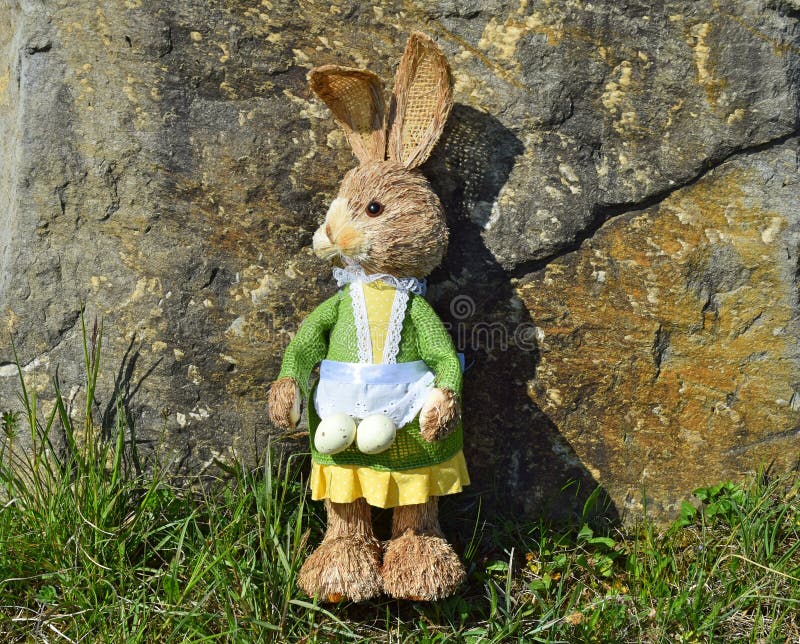 Easter Bunny in the Grass in Front of a Large Stone Stock Photo - Image ...