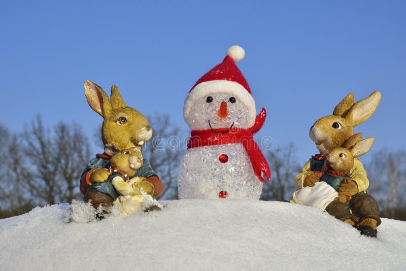 Easter bunny meets Snowman stock photo. Image of snow - 85634748