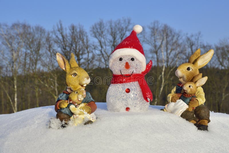 Easter bunny meets Snowman stock photo. Image of snow - 85634748