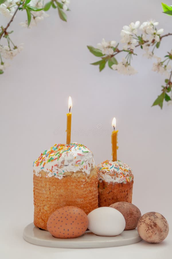 Easter Cakes with Burning Candles and Eggs on White Background Stock ...