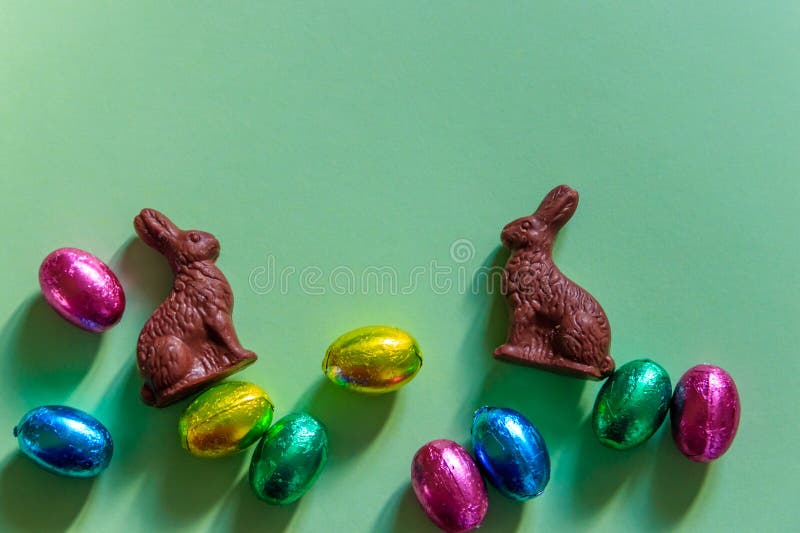 Easter Chocolate Eggs in Foil and Easter Chocolate Bunnies on Green ...