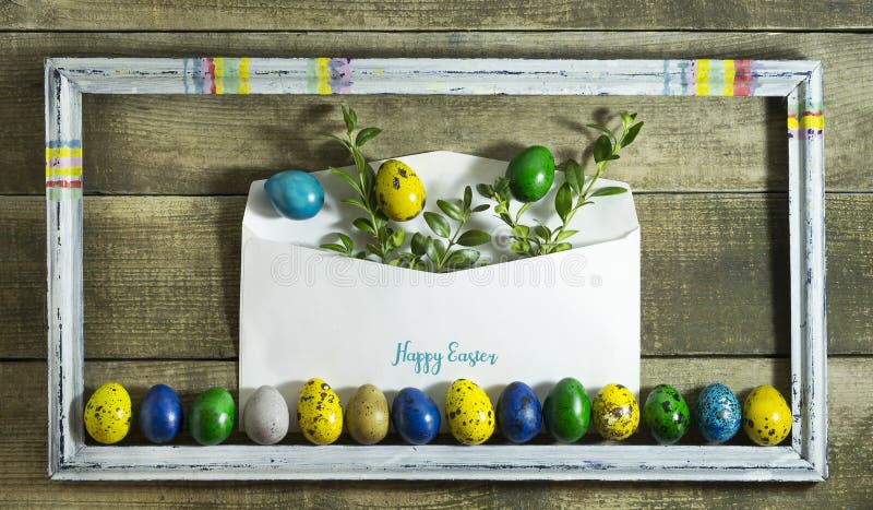 Easter Colored Eggs in a Postal Envelope on a Wooden Background Stock ...