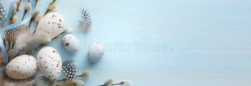 Easter Composition with Easter Eggs and Spring Flowers on Blue Table ...