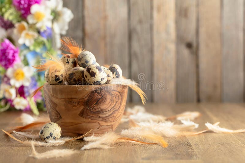 Easter Composition with Quail Eggs, Feathers, and Spring Flowers on a ...