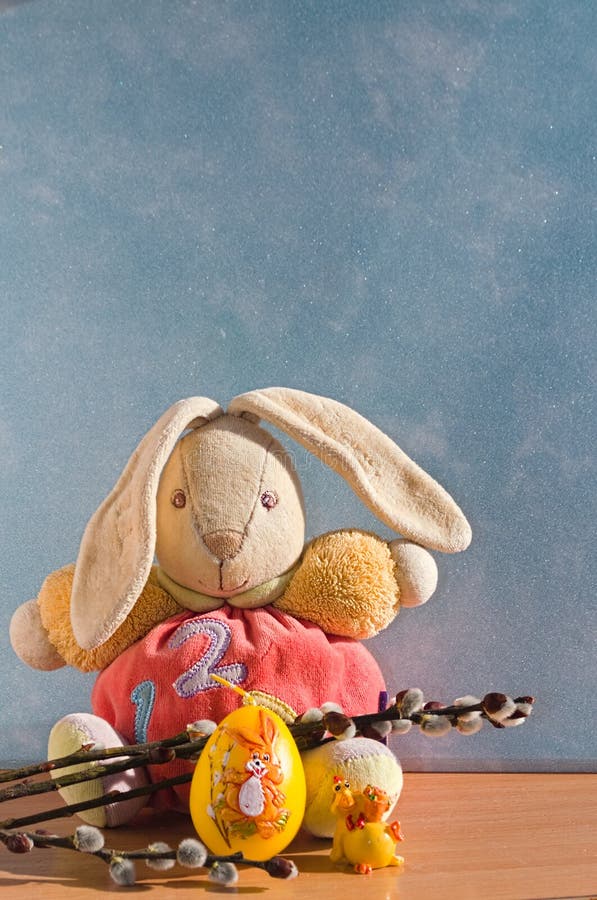 Easter Composition: a Soft Toy Rabbit with a Yellow Egg-candle with a ...
