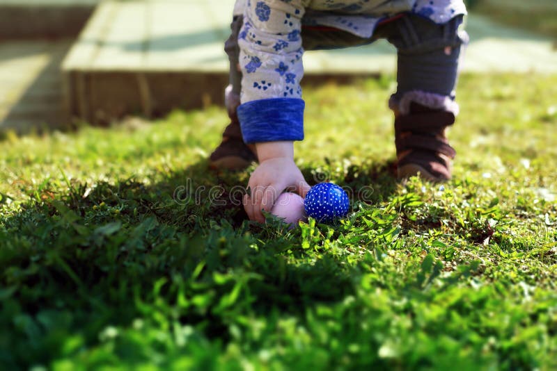 Easter Egg in Green Environment Gets Picked Up by a Child Stock Image ...