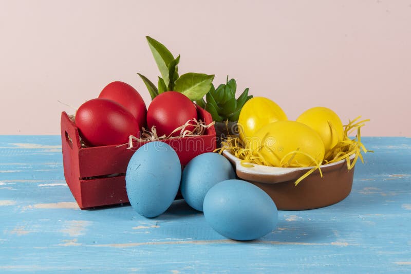 Easter Eggs of Different Colors in a Basket and Pots with Straw Stock ...
