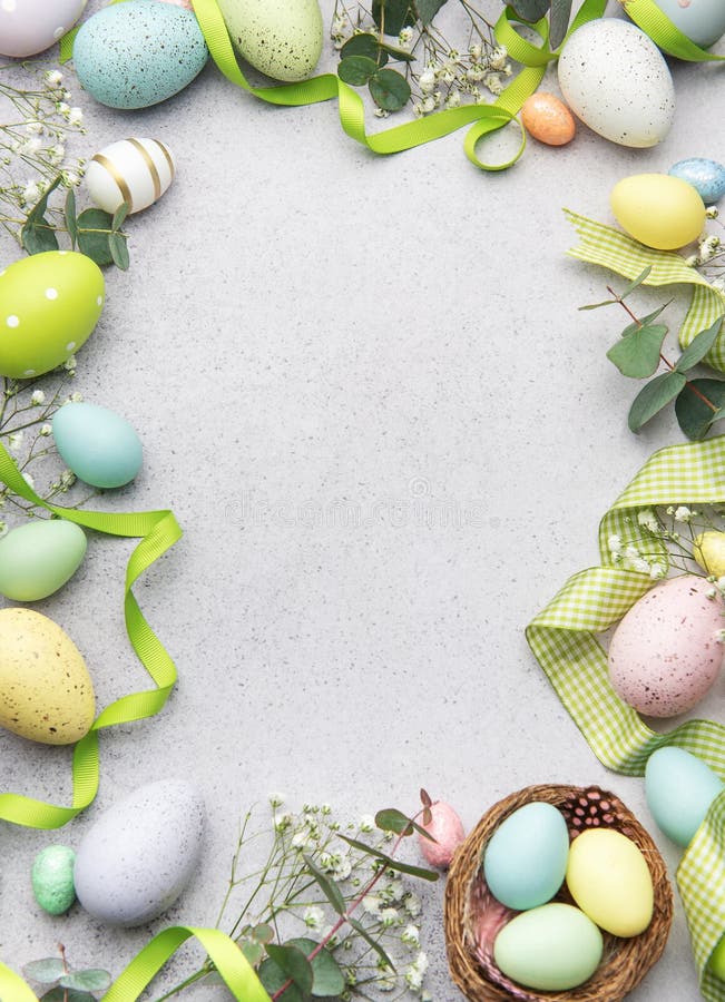 Easter Eggs Frame Decorating a Gray Surface with Ribbons and Flowers ...