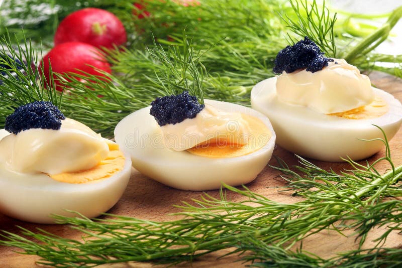 Easter Eggs with Mayonnaise and Black Caviar Stock Photo - Image of ...