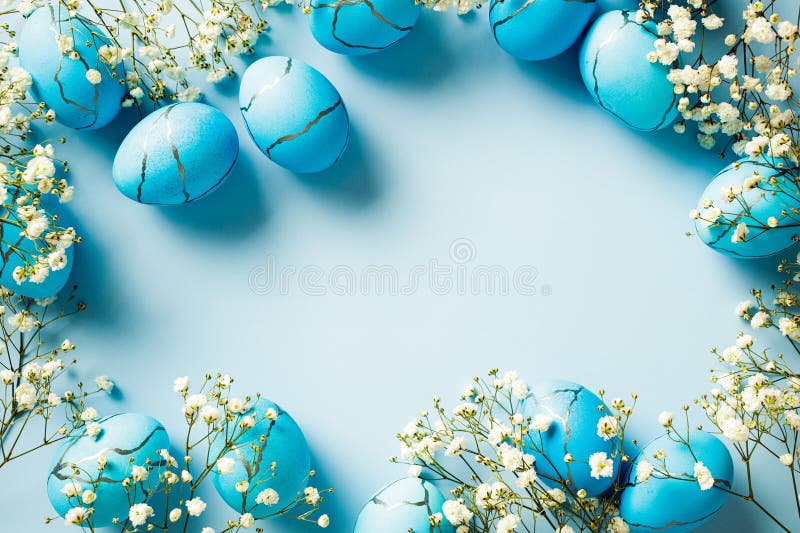 Easter Frame of Dyed Easter Eggs with Spring Flowers on Pastel Blue ...