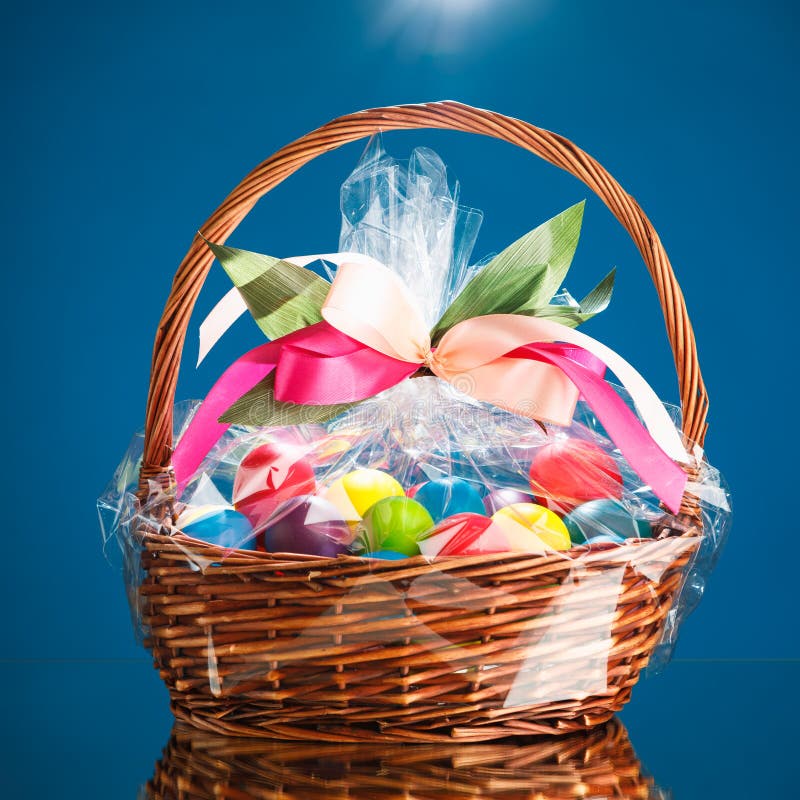 Easter Gift Basket with Multicolor Eggs, Blue Background Stock Photo ...