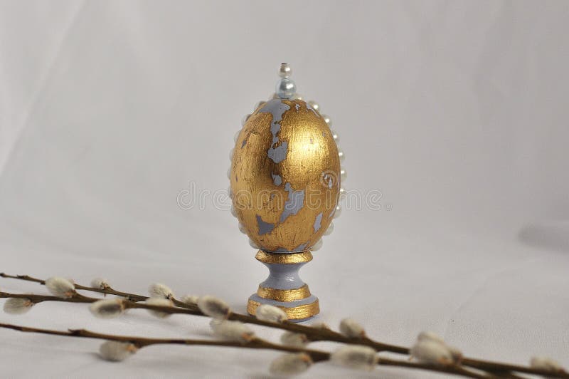 Easter.Golden Easter Egg on a Wooden Stand Stock Image - Image of ...