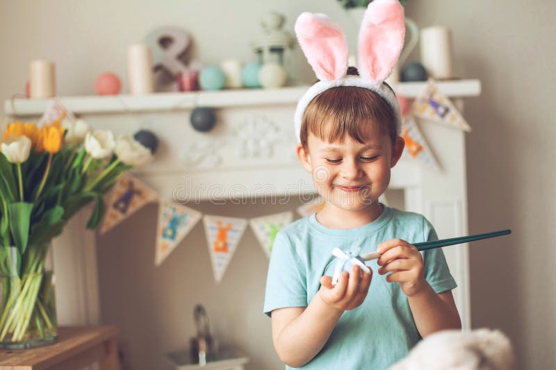 Easter. a Little Boy is Painting Easter Eggs Stock Photo - Image of ...