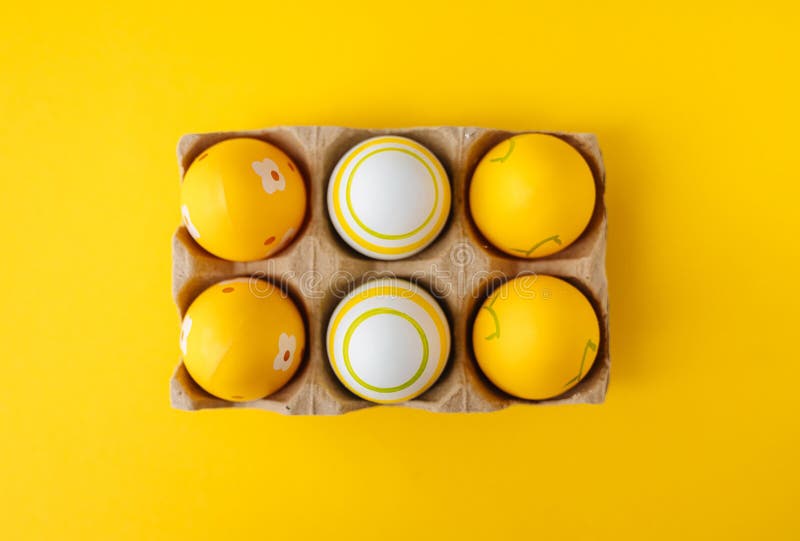 Easter Poster. Blue, Yellow and White Easter Eggs on Yellow Background. Top View. Flat Lay ...