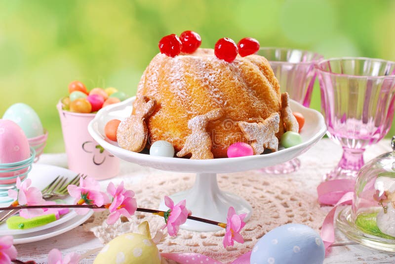 Easter Ring Cake with Candy Eggs and Cookies on Spring Table Stock ...