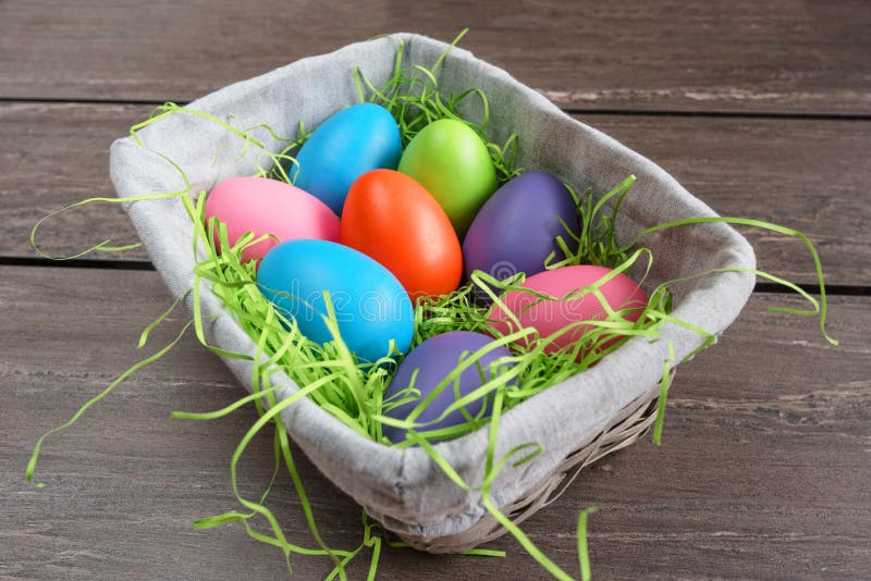 Easter Wicker Basket with Colored Eggs on Grey Wooden Board. Stock ...