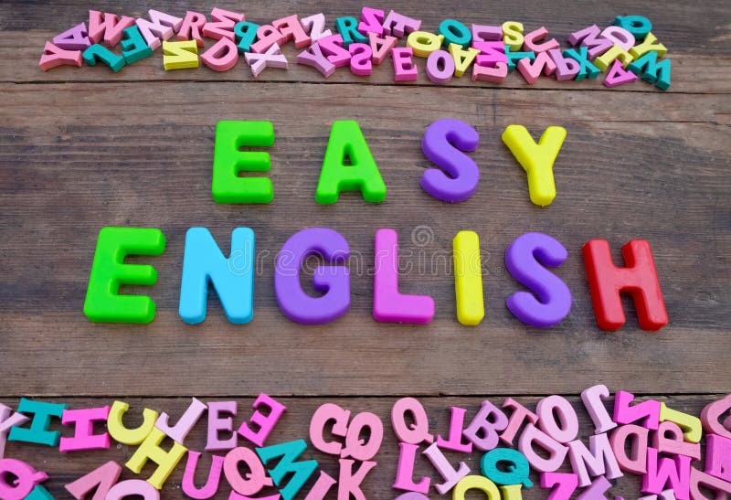 Easy English Phrase on an Wooden Table. Many Plastic Letters of the ...