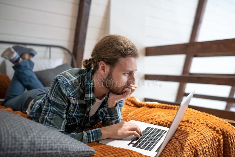 Concentrated Man Working with Computer on His Bed Stock Image - Image ...