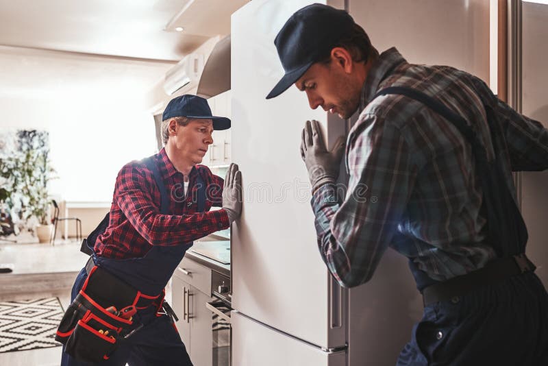 Easy To Solve. Young Men Mechanics Checking Refrigerator Stock Image ...