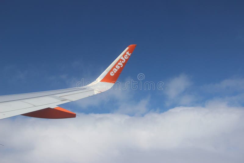 Easyjet Airplane Wing Flying Above the Clouds in the Blue Sky Editorial ...