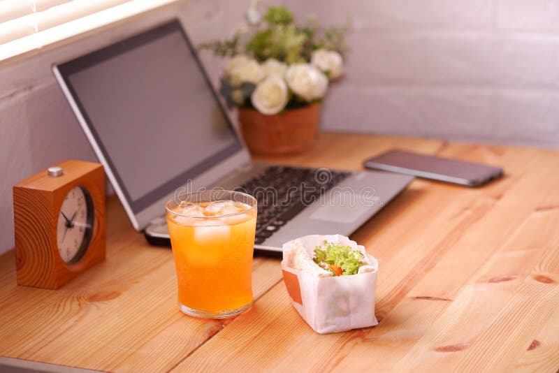 Eat Sandwich and Orange Juice. during Work with Laptop Computer. Work ...