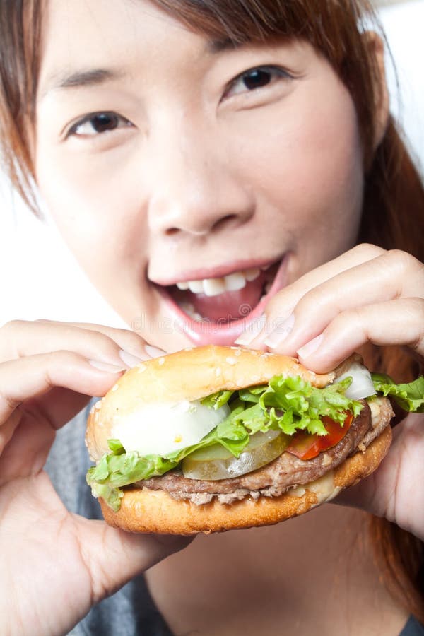 Eating Burger stock image. Image of cute, asian, dinner - 25913827
