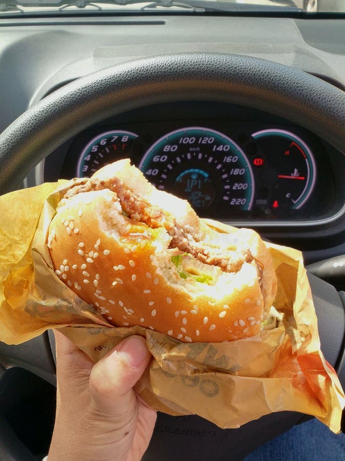 Eating burger in a car stock image. Image of food, lunch - 185715857