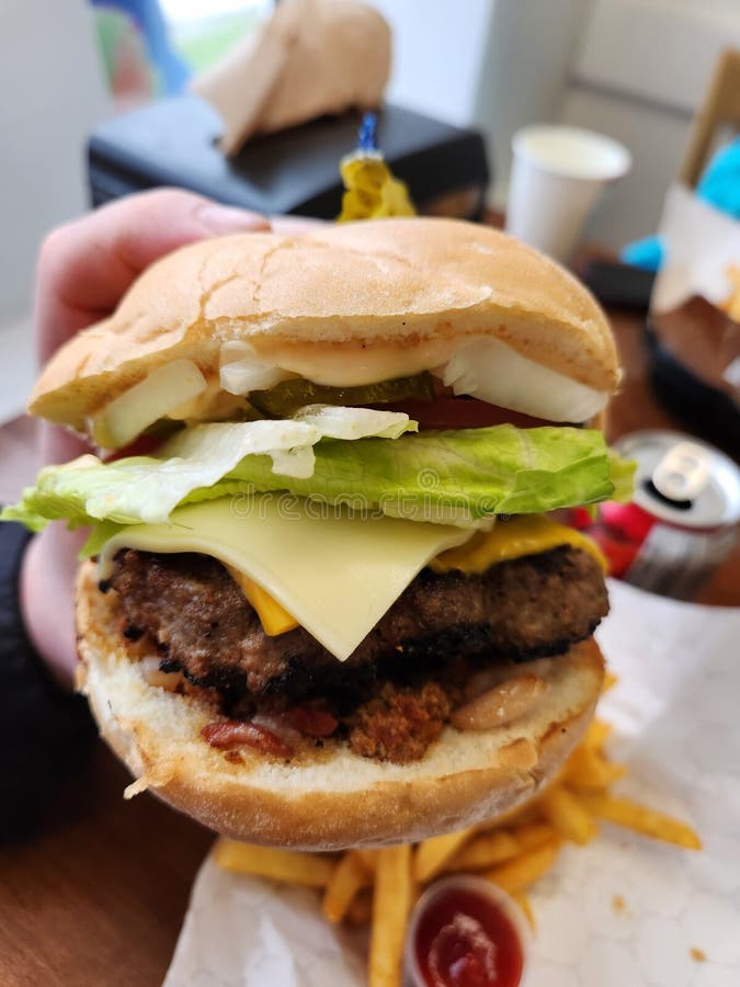 Eating Burger at Restaurant Cheeseburger Lettuce Bun Stock Photo ...