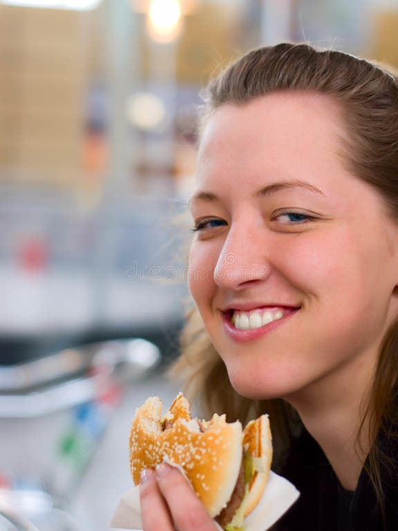 Eating cheeseburger stock image. Image of burger, brunette - 9510729