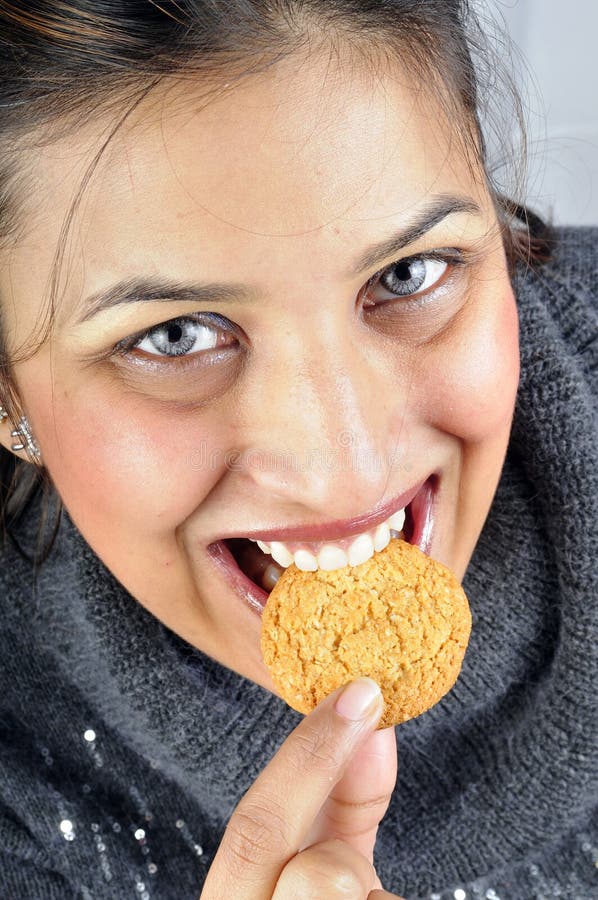 Eating cookie stock image. Image of model, cookie, asian - 12694413