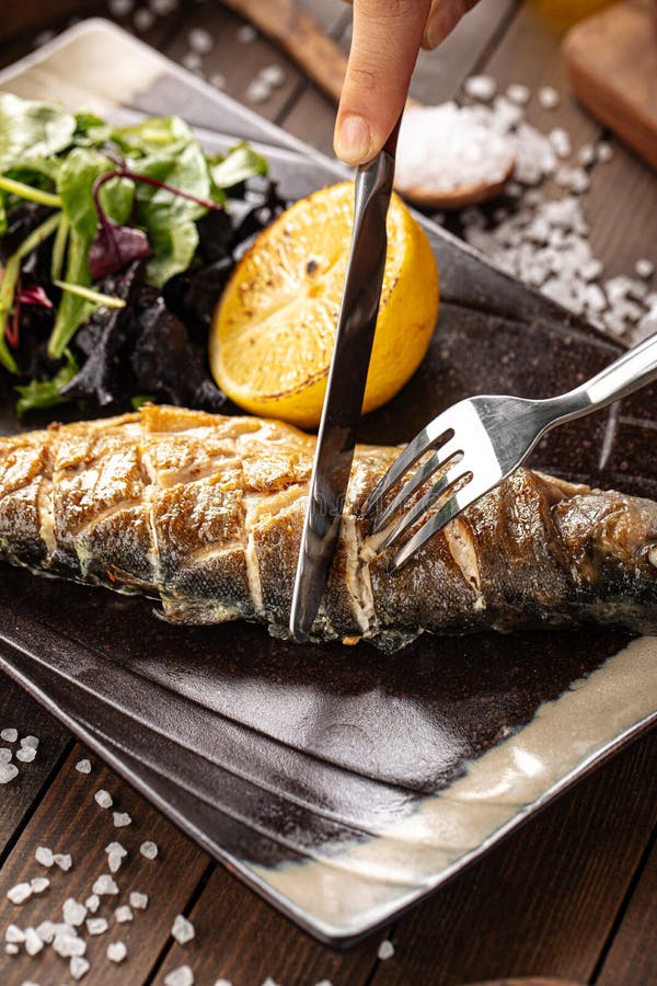 Eating Gourmet Grilled Fish Stock Photo - Image of seafood, plate ...