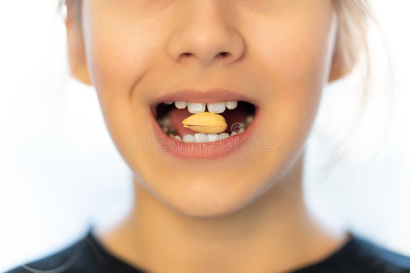 Eating Hard Nuts. Strong White Teeth Bite Nut. an Open Mouth with a Nut ...