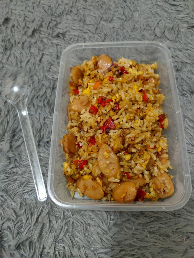 Eating Hot Fried Rice Complete with Sausage and Meatball Stock Photo ...